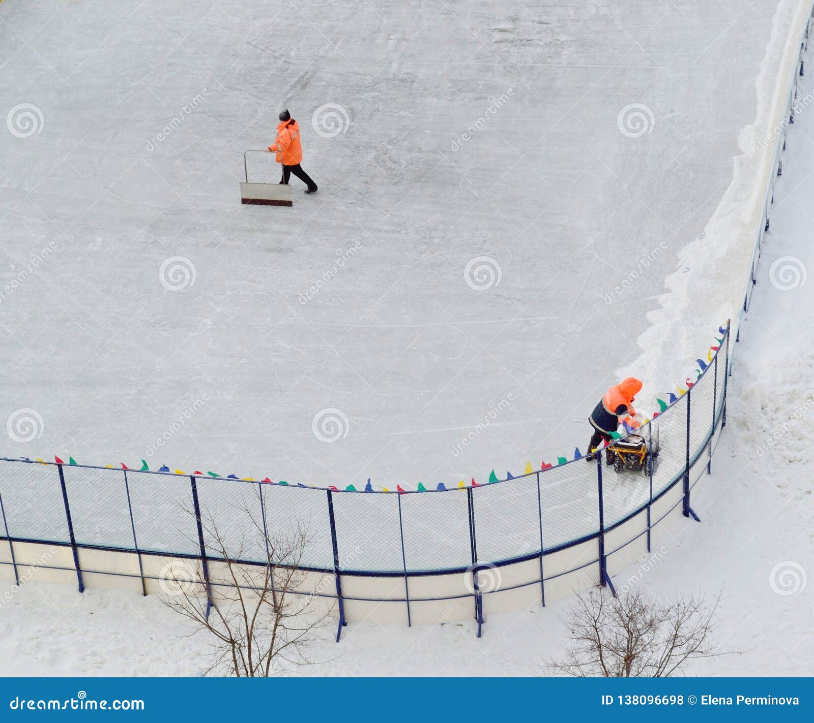 Cleaning of the Ice Rink from the Snow in the Yard of the House Stock ...