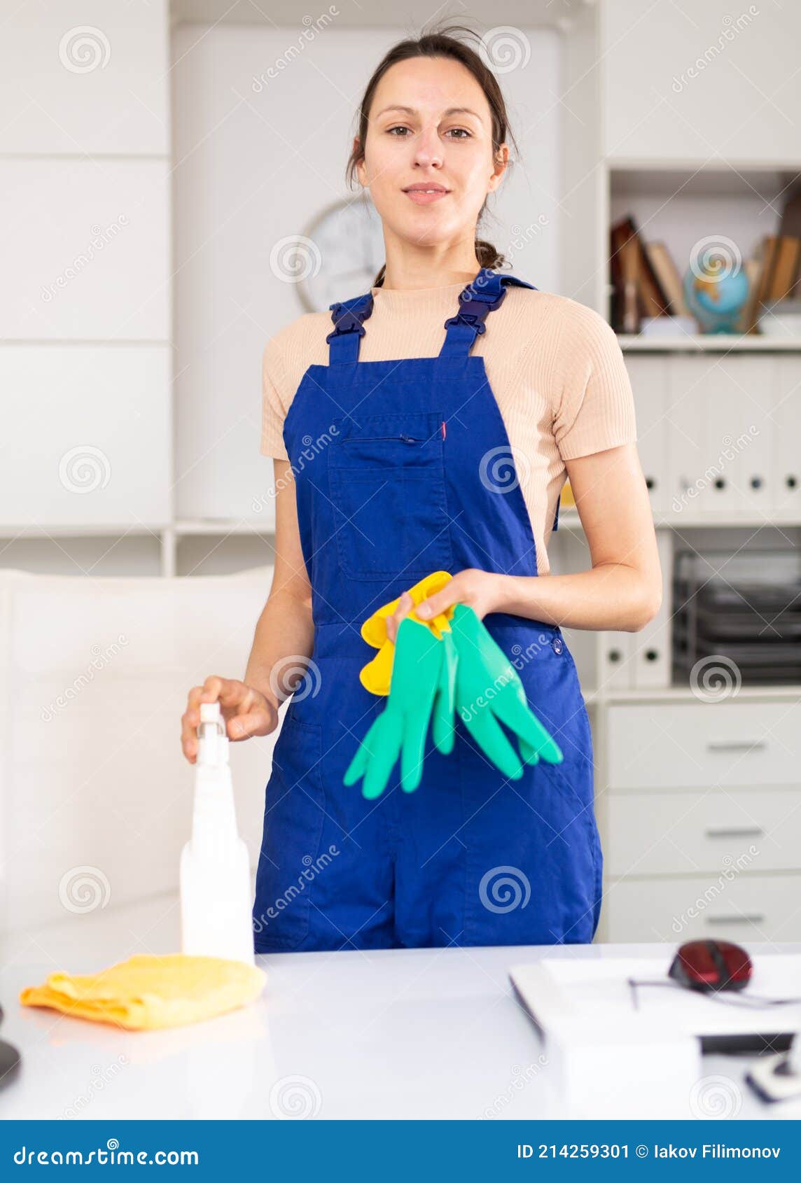 Cleaning Lady in Overalls Wipes Dust from Table in Office Stock Image ...
