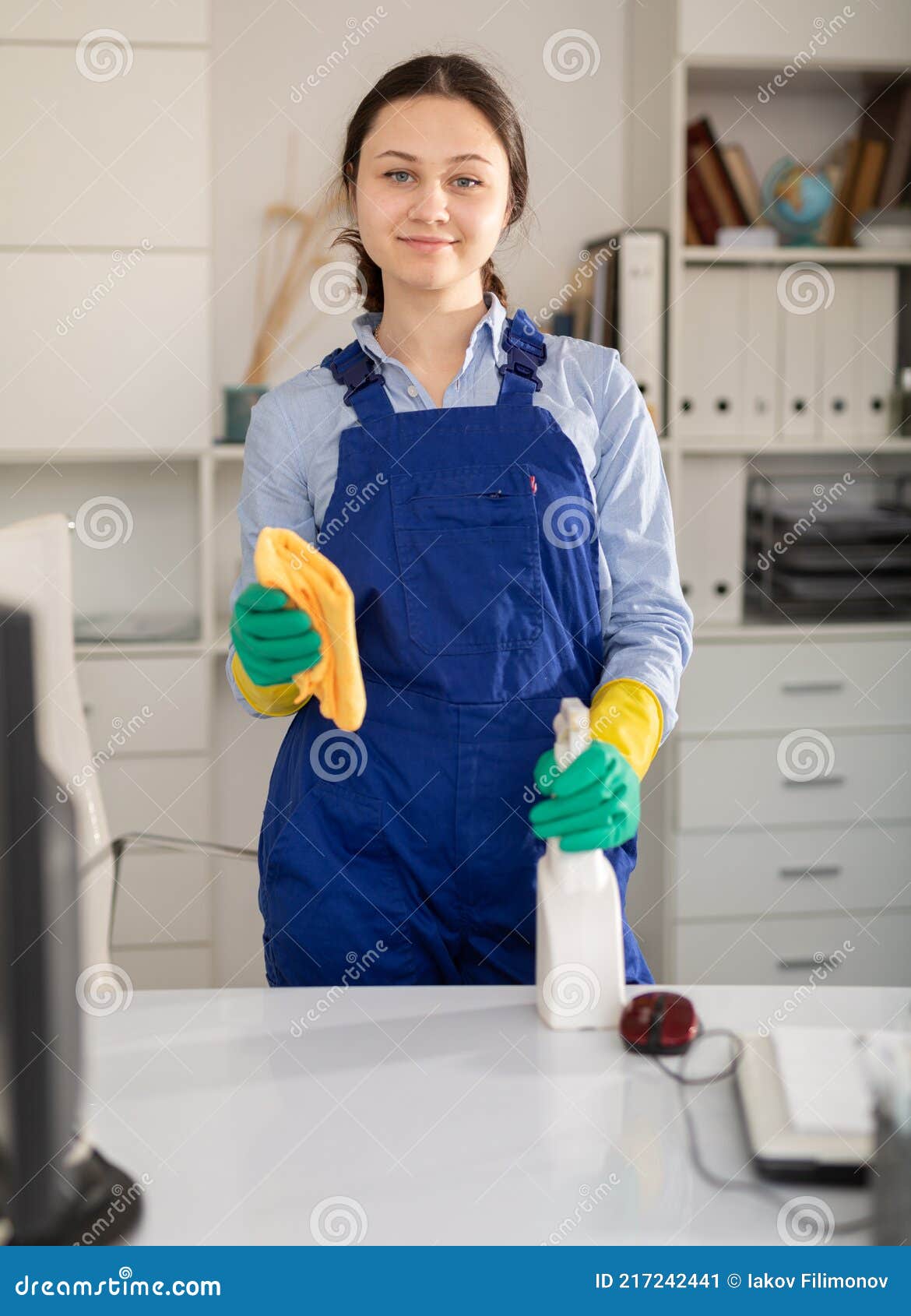 Cleaning Lady in Overalls Wipes Dust from Table in Office Stock Image ...