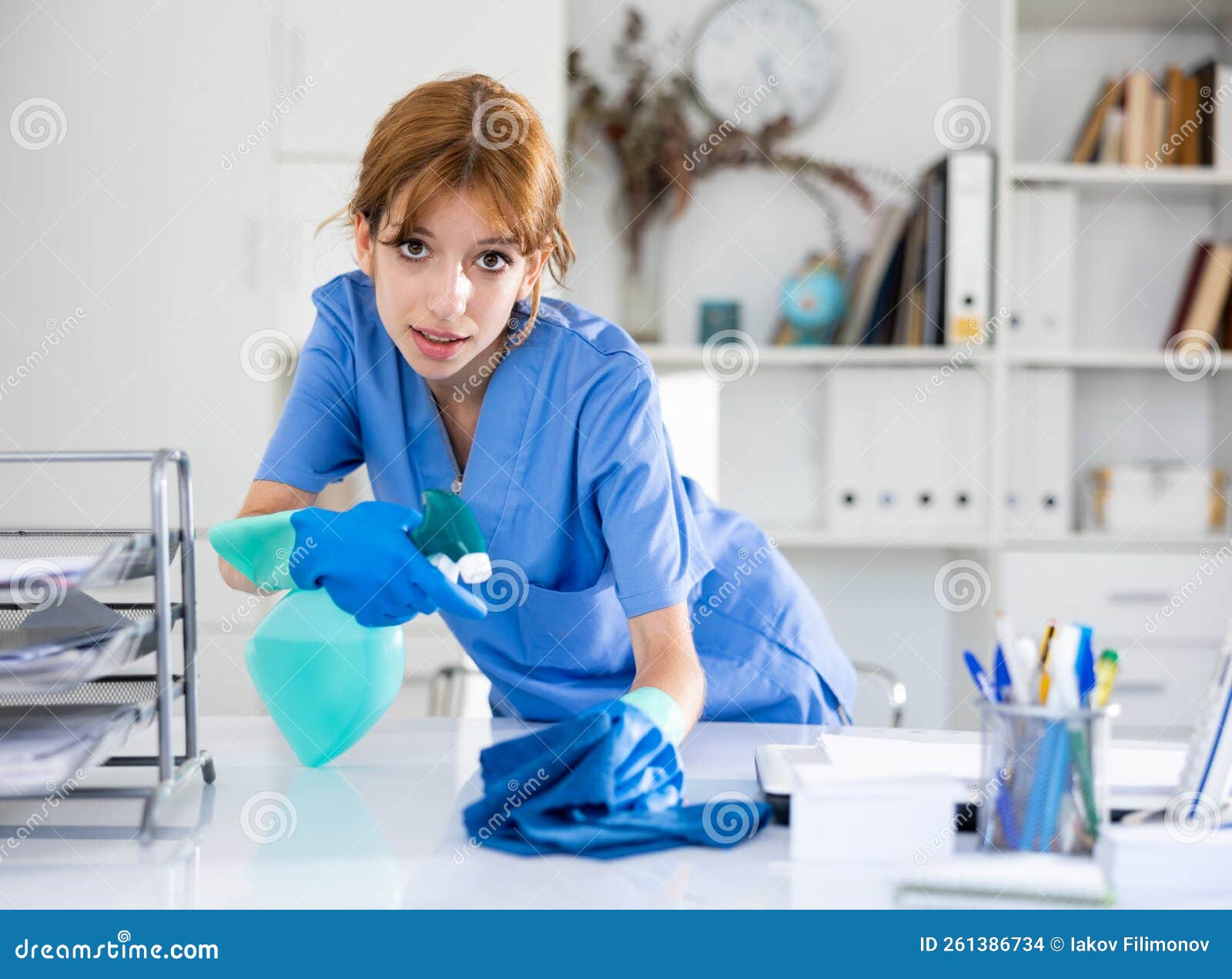 Cleaning Lady in Uniform Wipes Dust from Table in Office Stock Photo ...