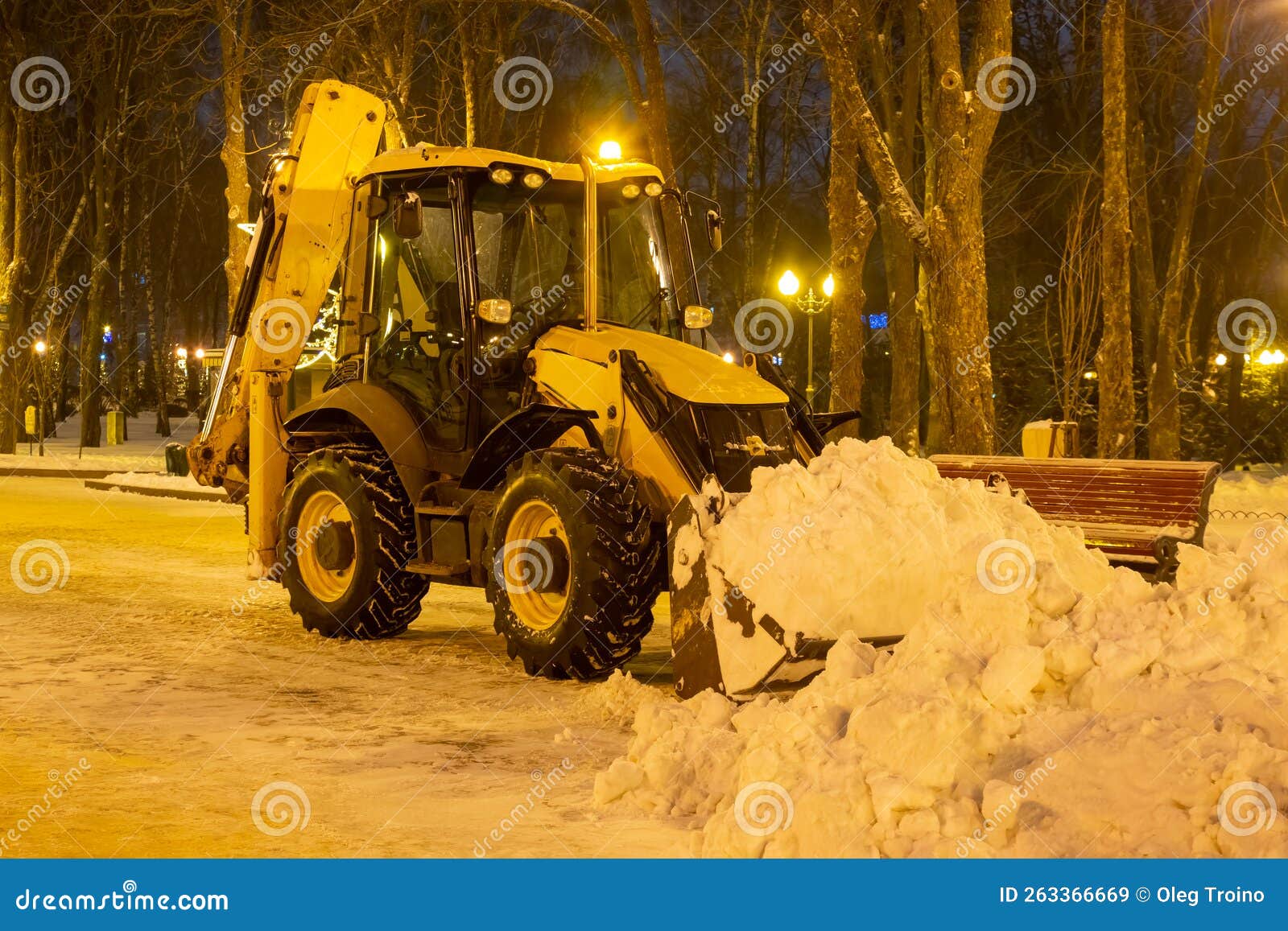 Cleaning Snow in the Park in Winter with a Tractor in the Evening Stock ...