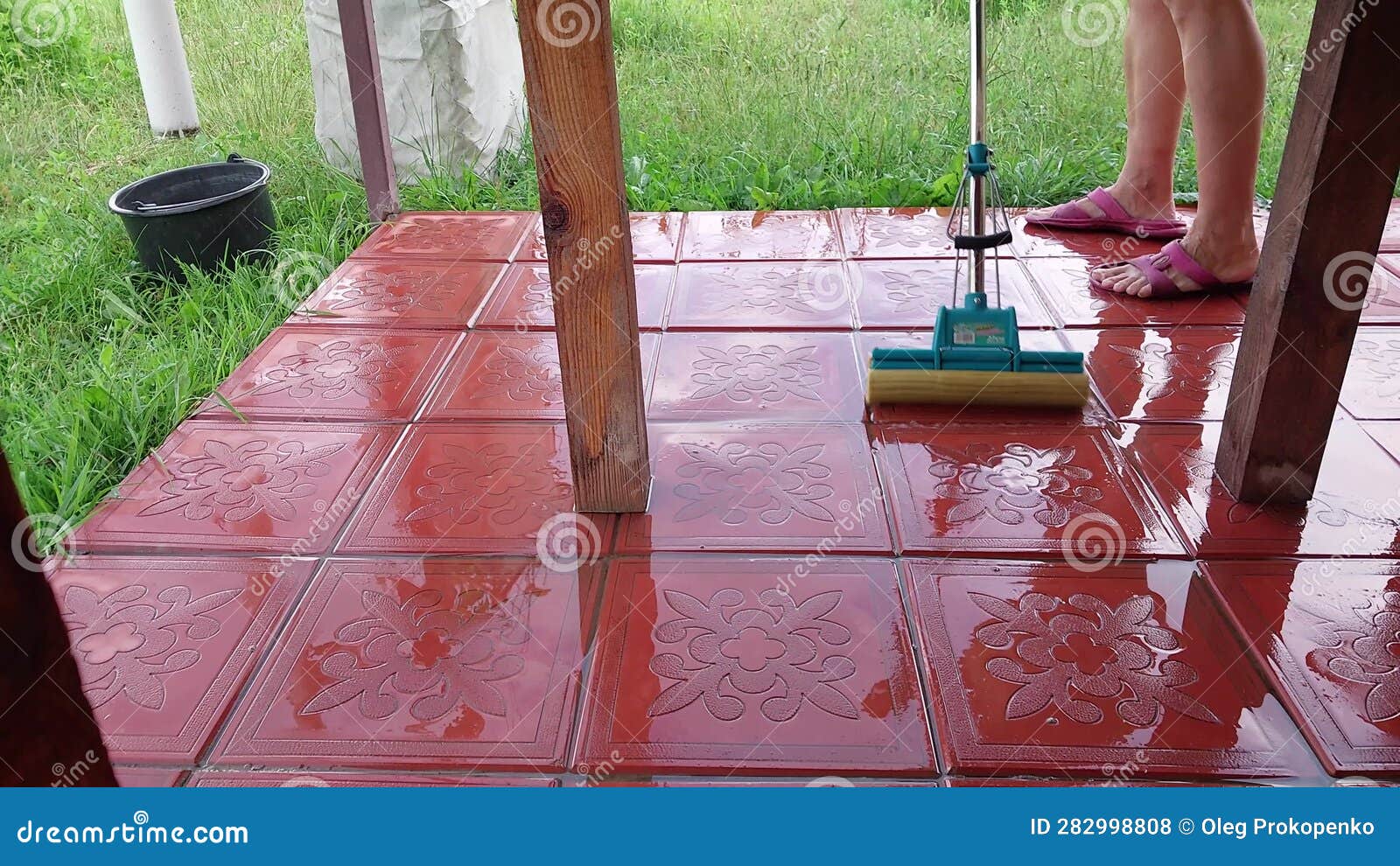 Cleaning the Tile Floor after the Rain with a Mop Stock Footage - Video ...