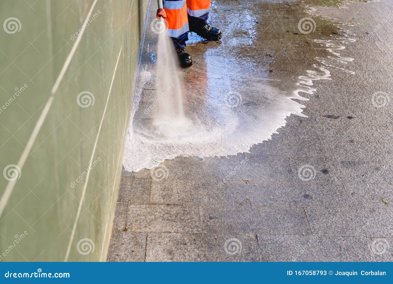 Cleaning Worker Throwing Pressure Water To Clean the Sidewalks of a ...