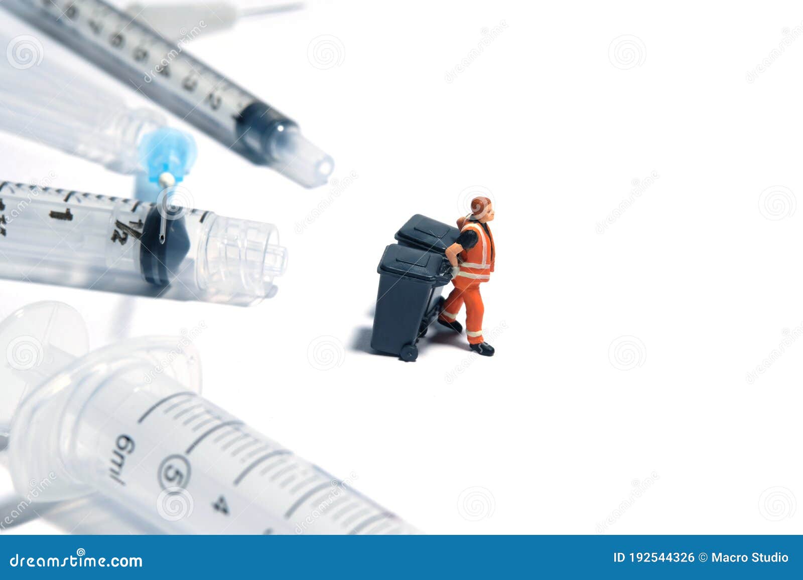 Cleaning Workers Pulling Trash Bin, in Front of Syringe that Has Been ...
