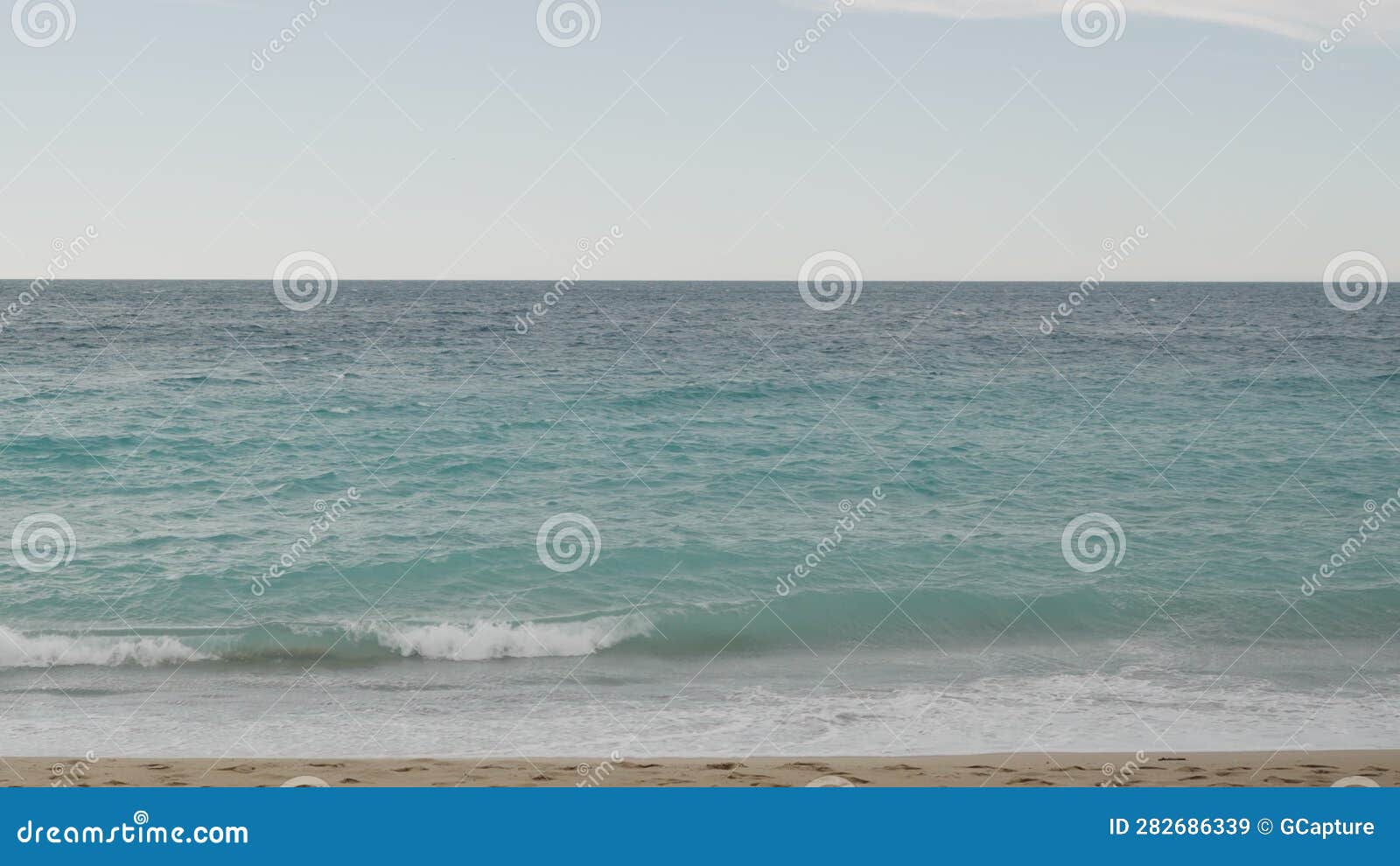 Clear Blue Waves with Strong Wind on a Sandy Empty Beach in Cannes in ...