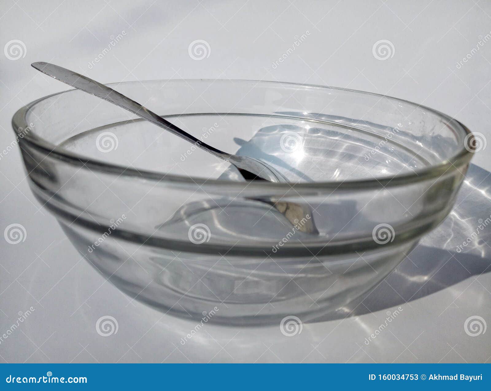 A Clear Bowl and Spoon Inside with a White Background Stock Image ...