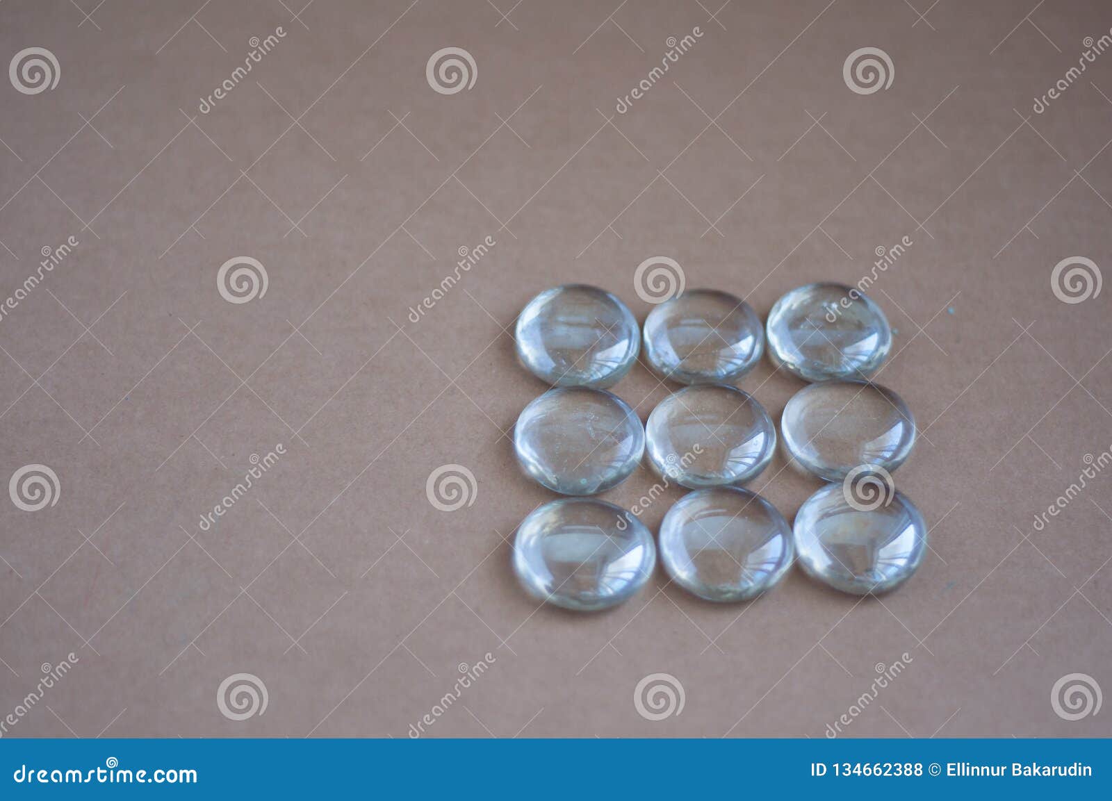 Clear Marbles with Light Reflections on a Brown Background. Stock Photo ...