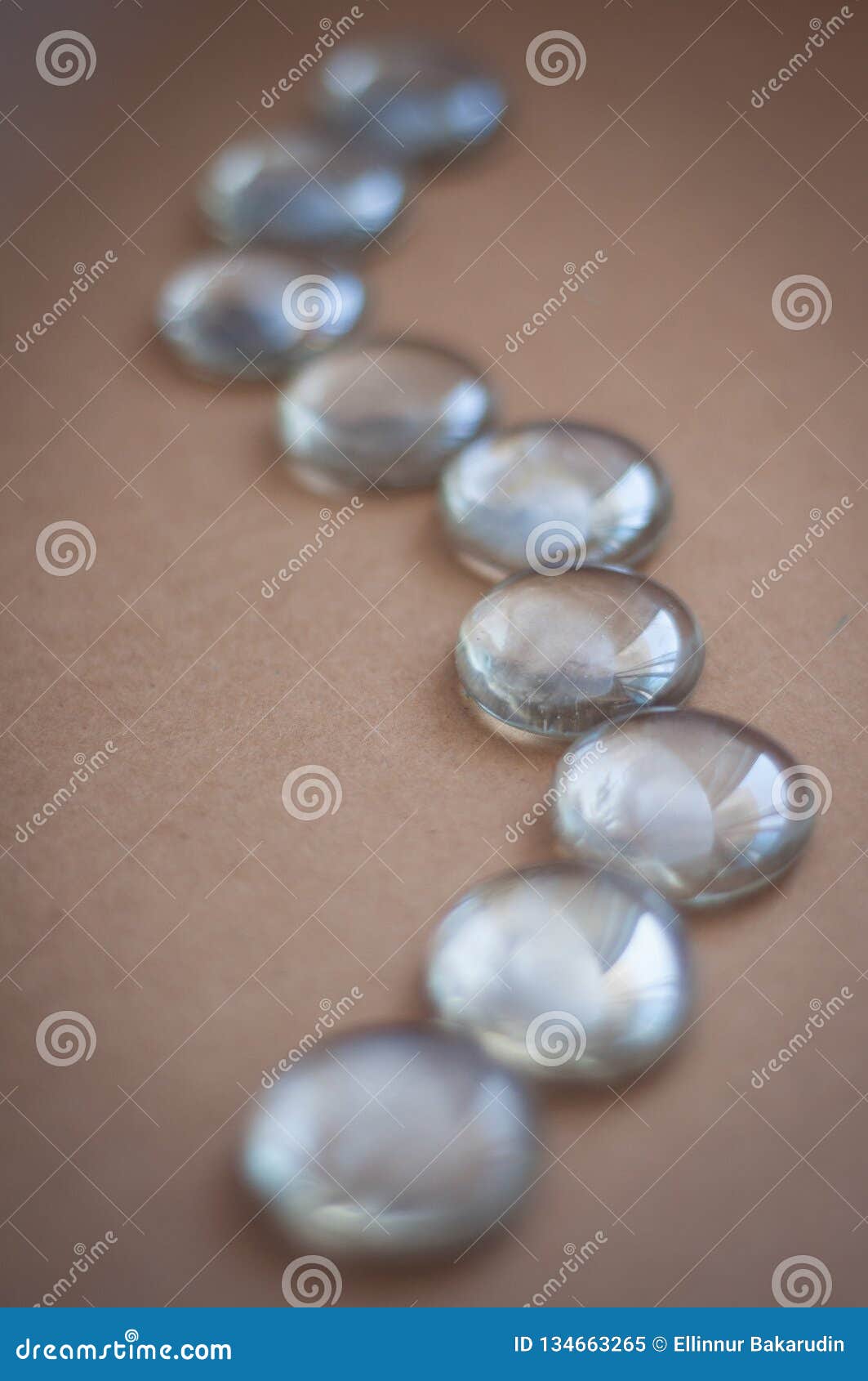 Clear Marbles with Light Reflections on a Brown Background. Stock Image ...