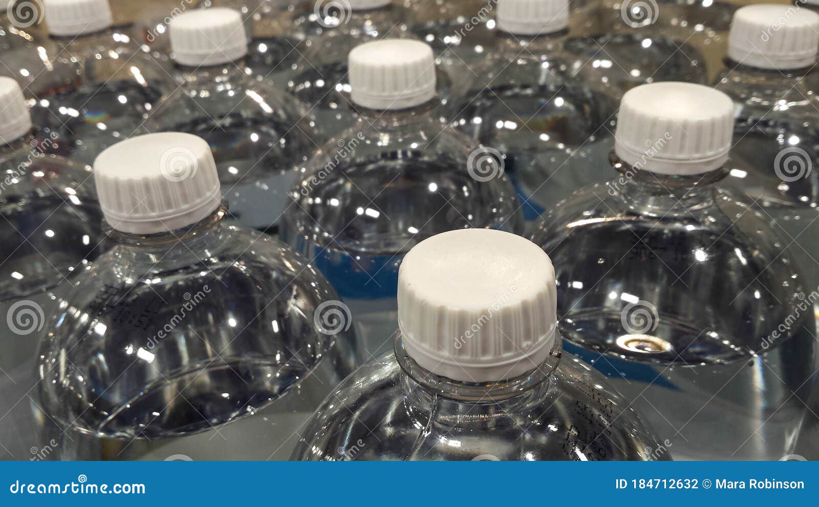Clear Plastic Bottle with Liquid Water Inside and White Plastic Caps on ...
