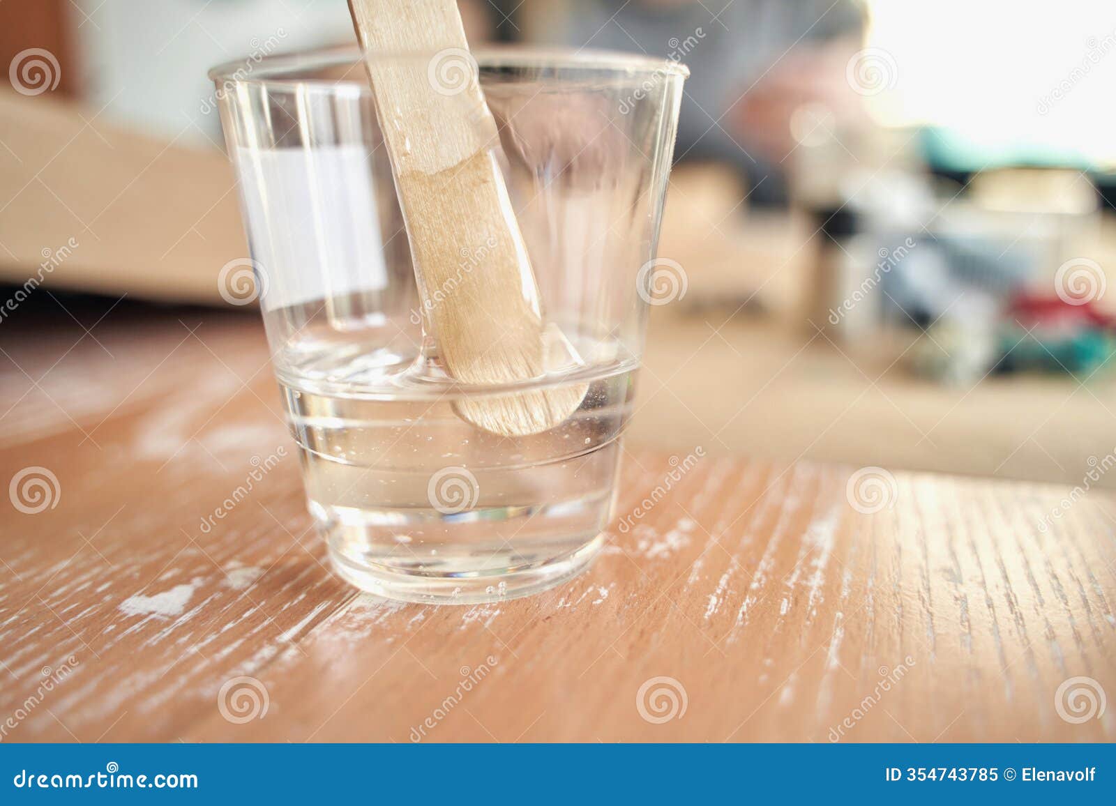 Clear Plastic Cup with Stir Stick on Wooden Surface in Well Lit Room ...
