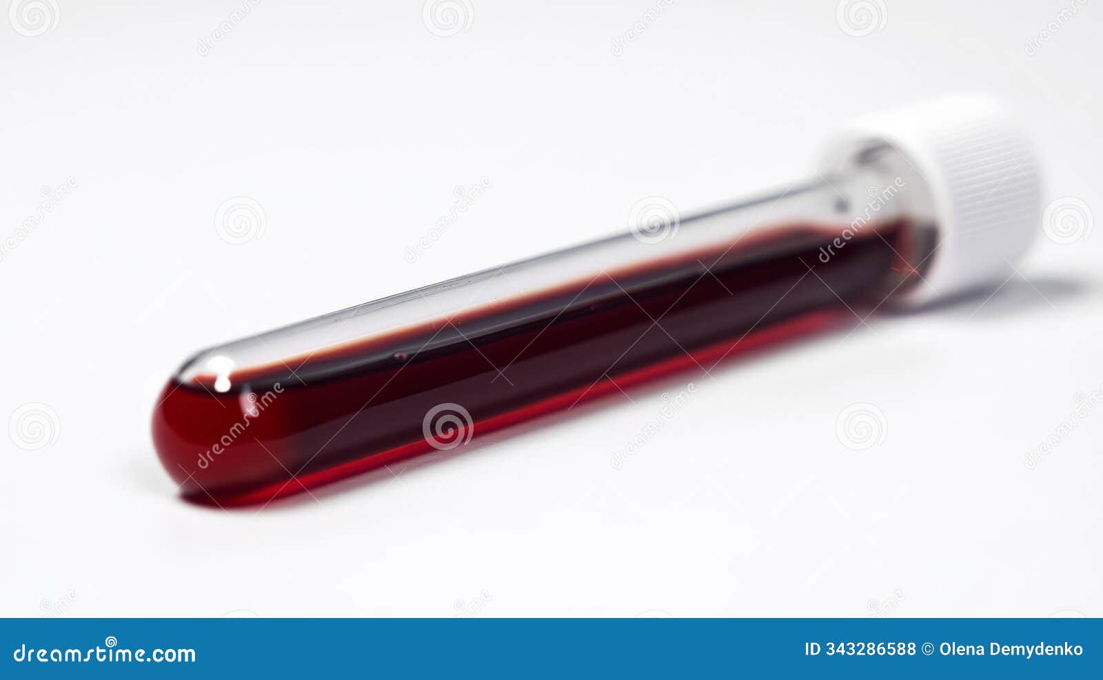 A Clear Test Tube Containing a Dark Red Liquid is Resting on a White ...