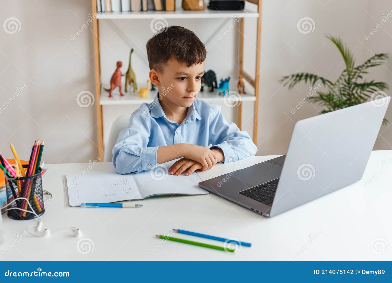 Clever Kid Doing Homework Using Laptop and Internet Stock Photo - Image ...