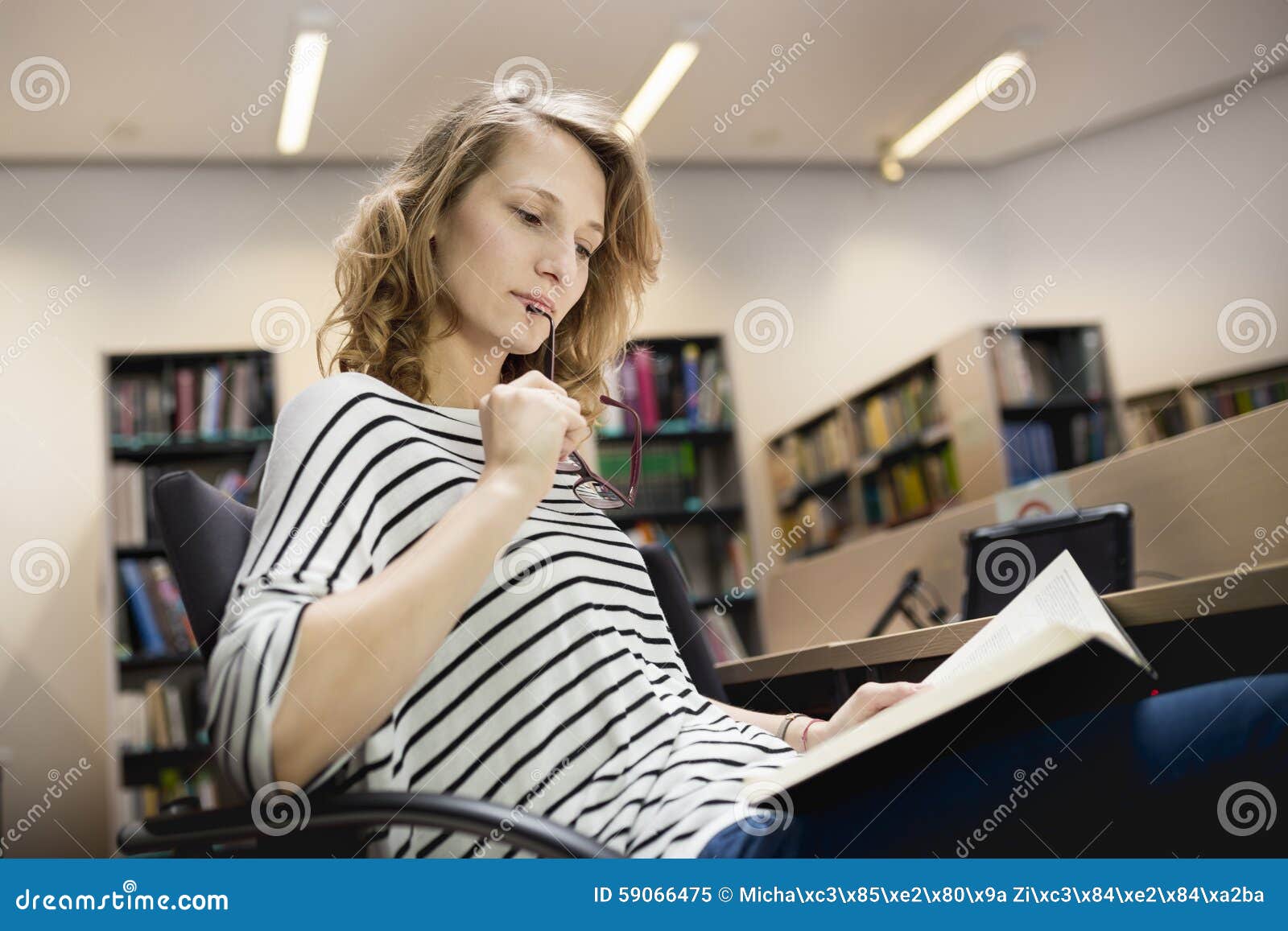 Clever Student with Open Book Reading it in College Library Stock Image ...