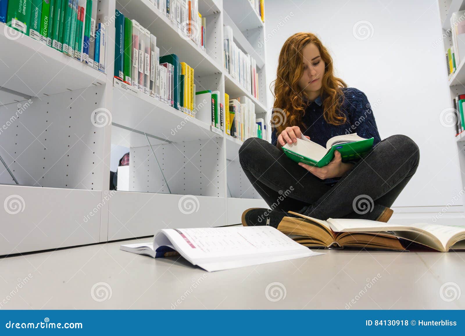 Clever University Student Studying in White Modern Library Books Stock ...