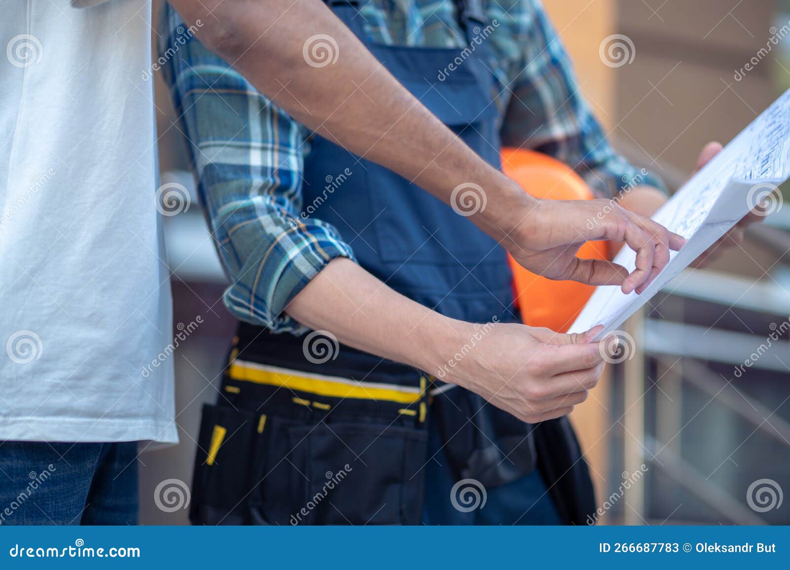 Client Discussing a Residential Plumbing Plan with a Construction ...