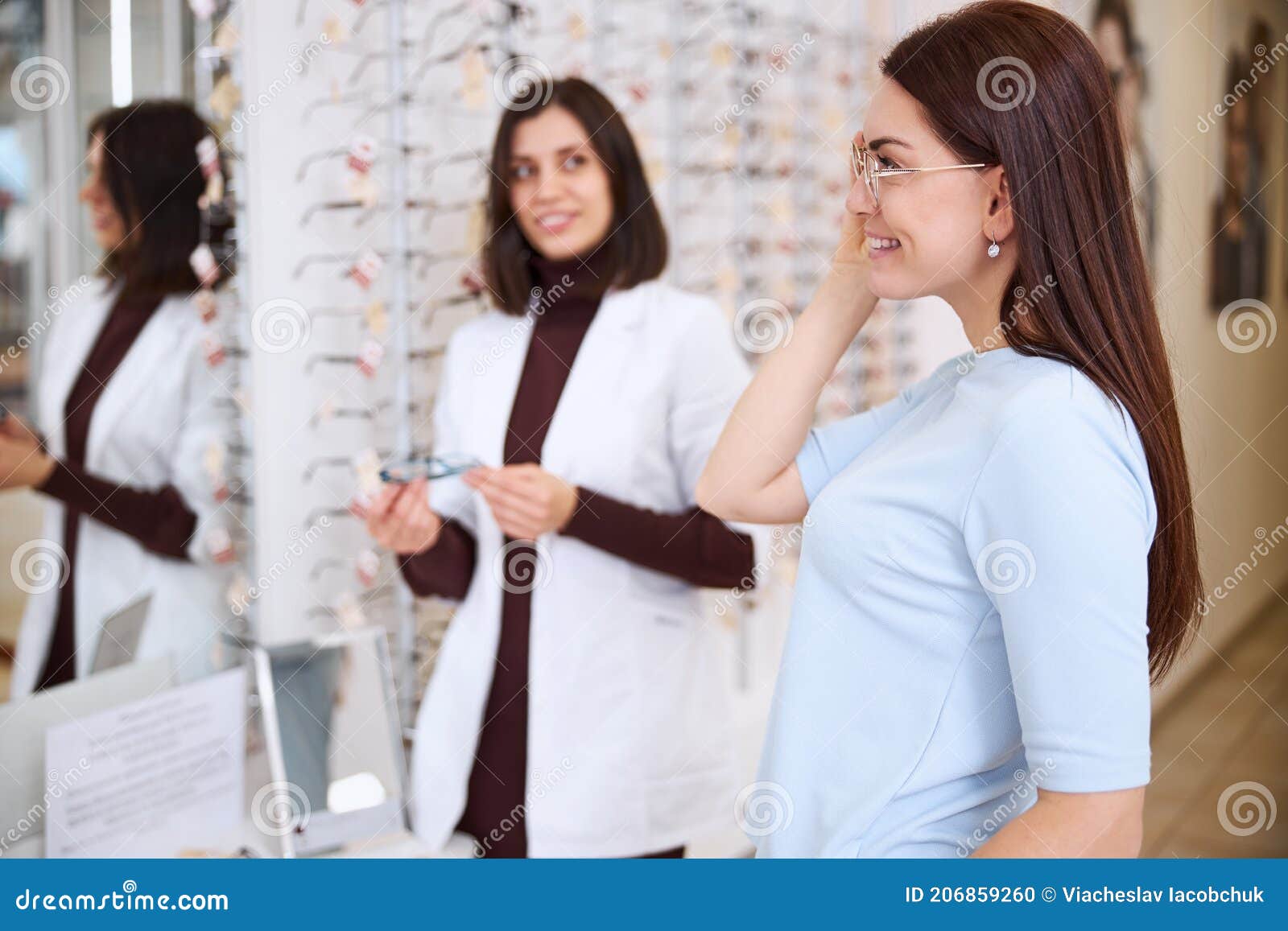 Client Inspecting Her Appearance in a Wall Mirror Stock Photo - Image ...