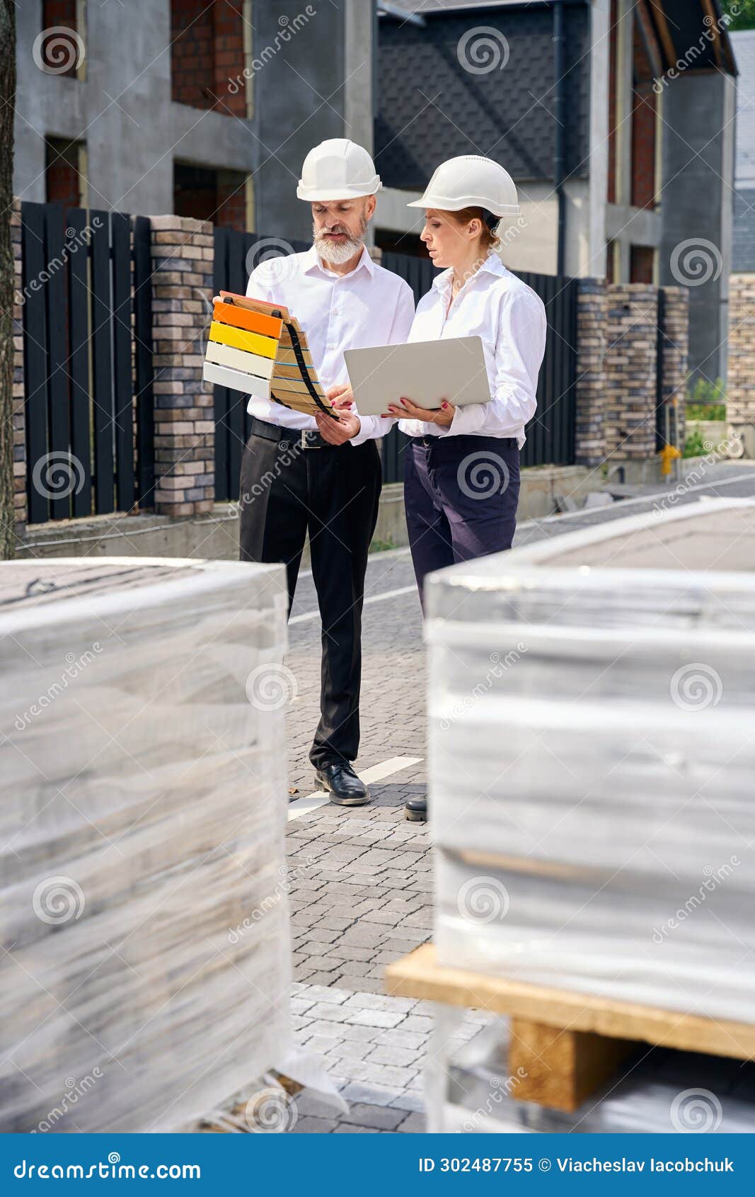 Client Picking Facade Paint Color with Help of Construction Expert ...