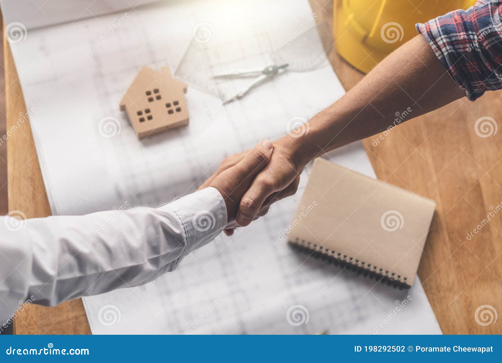 Client Shaking Hands with Contractor after Confirm Blueprint To ...