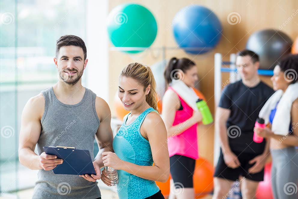 Client and Trainer Looking at Clipboard Stock Photo - Image of care ...