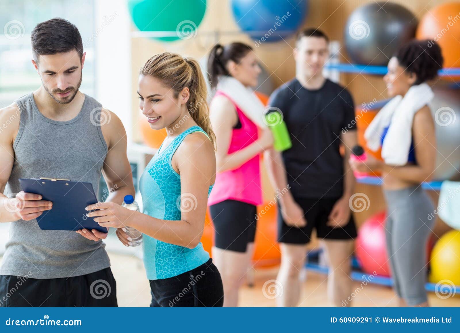 Client and Trainer Looking at Clipboard Stock Image - Image of female ...