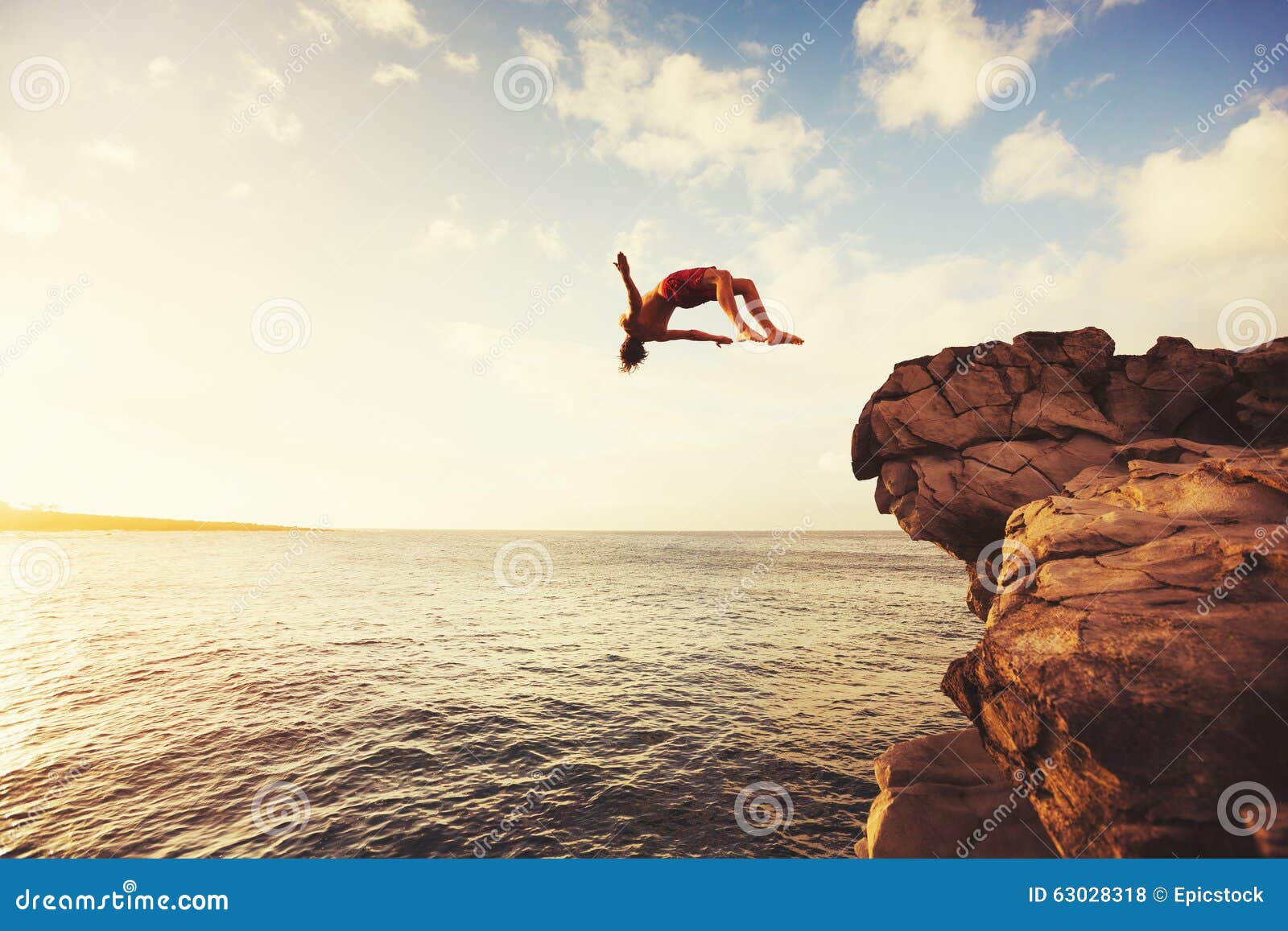 Jumping From The Cliff Near Sarakiniko Beach In Milos In The Cyclades ...