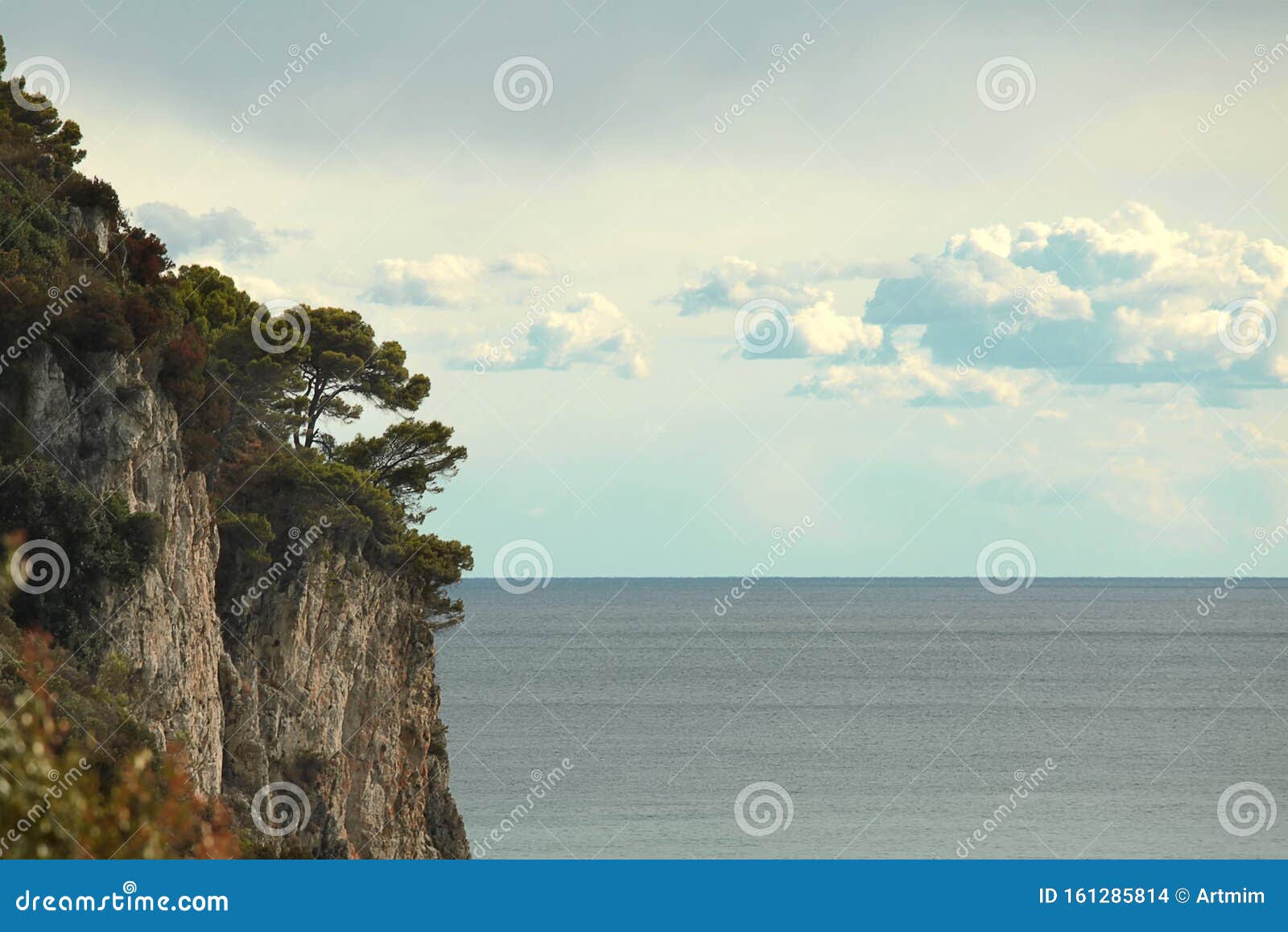 Cliff with Trees and Stones. Sea Space and Clouds Stock Photo - Image ...