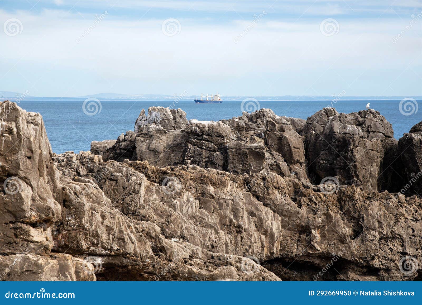 Cliffs Against the Background of the Blue Atlantic Ocean and a Ship in ...