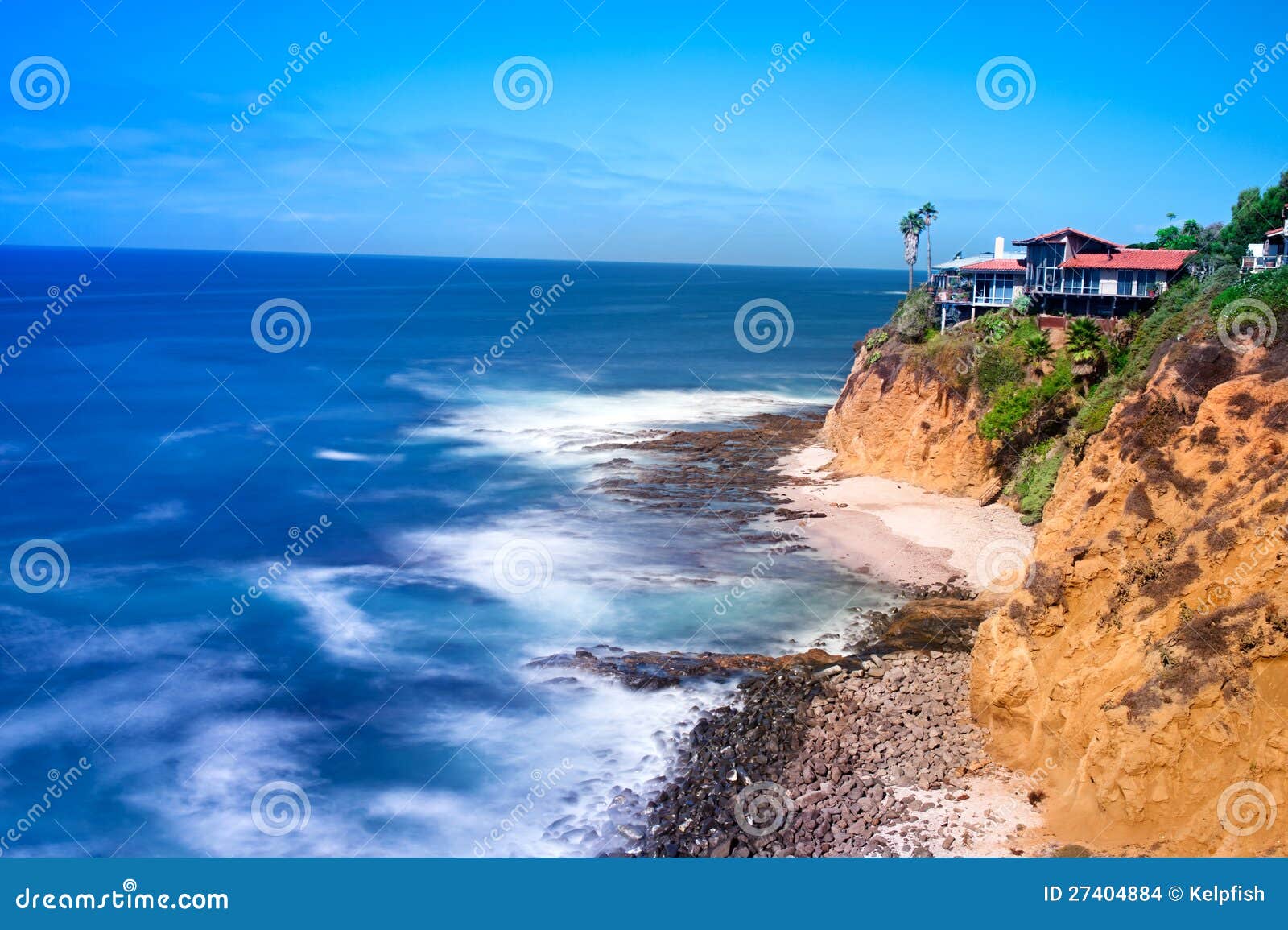 Cliffside Home Overlooking Ocean Stock Photo - Image of serene, orange ...
