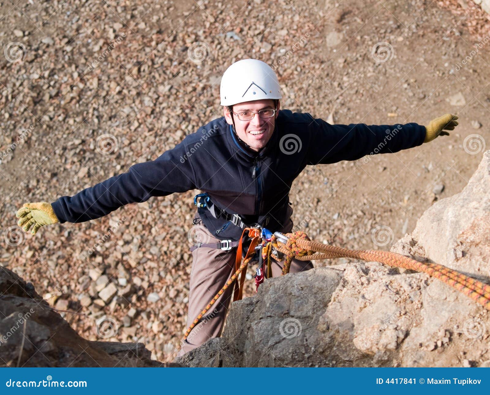 Climber Hanging On The Rock With Arms Wide Open Picture. Image: 4417841