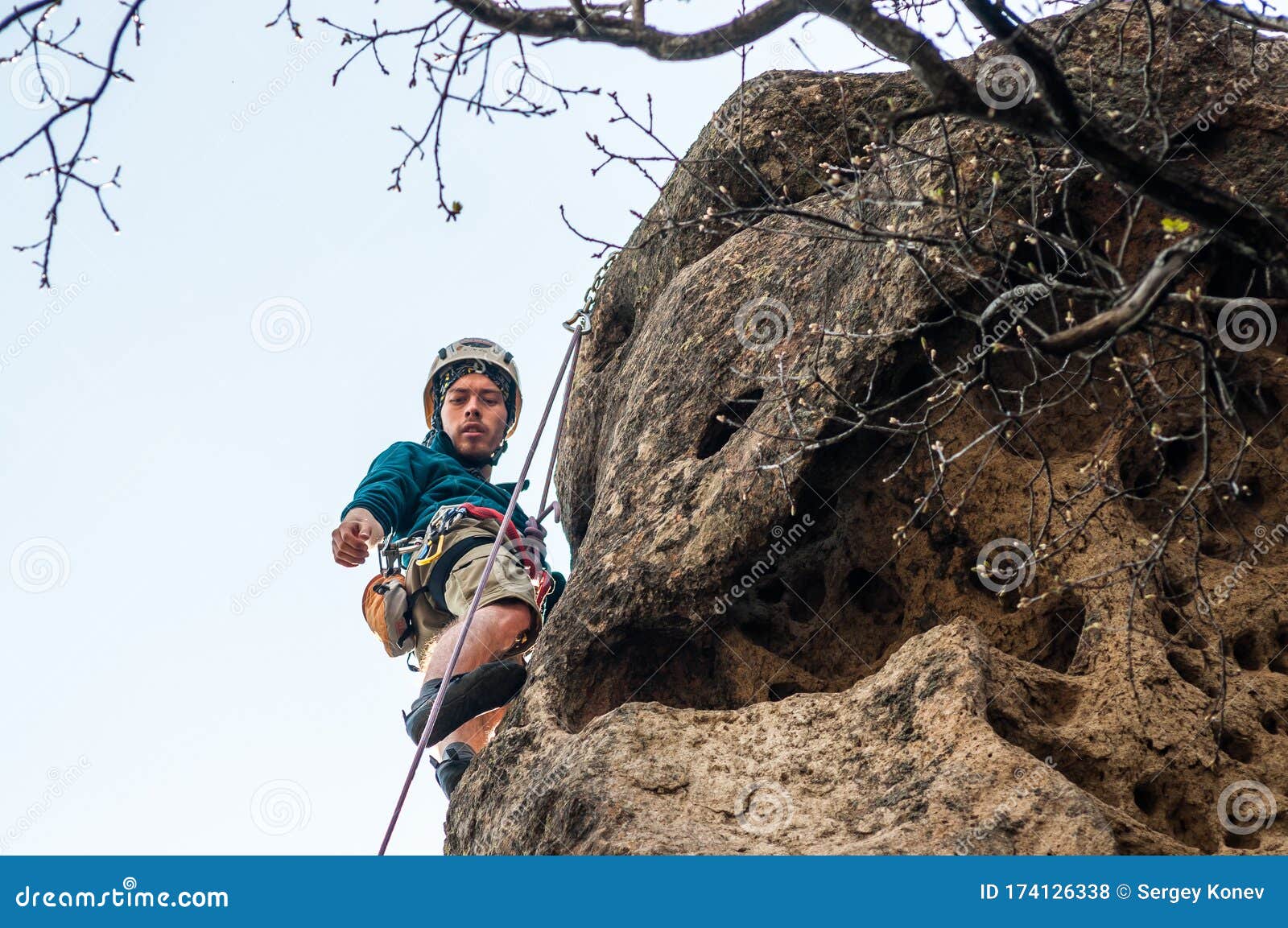 A Climber Looking Down from the Top of the Cliff. Stock Photo - Image ...