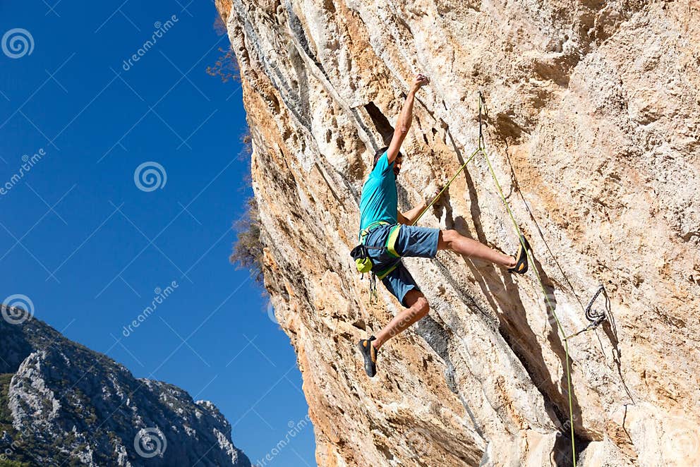 Climber Making Risky Move on Dangerous Rock Stock Image - Image of ...