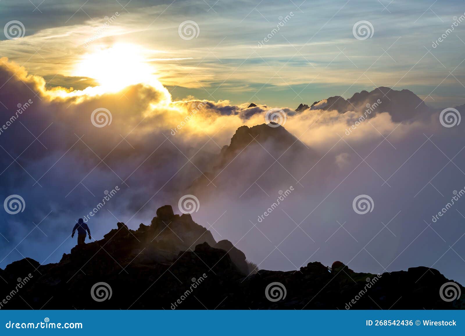 Climber Walking Along a Ridge during a Sunrise in the Clouds, Tatra ...