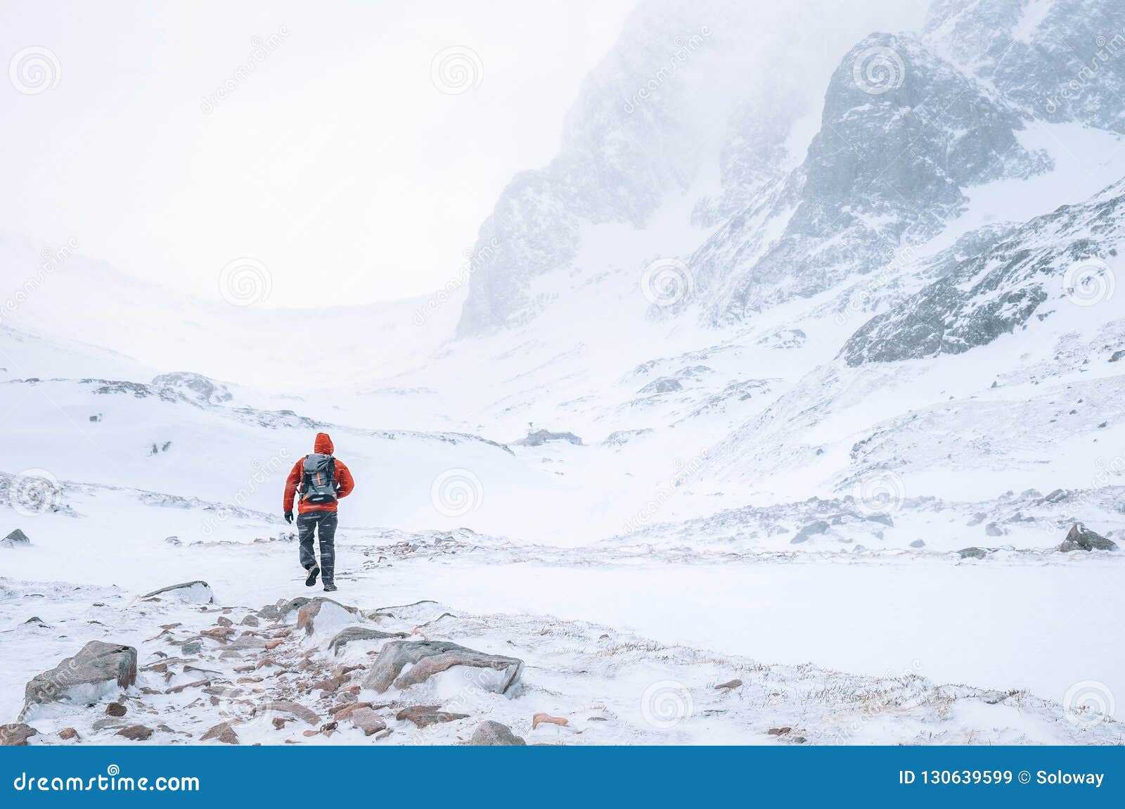 Climber Walks Alone in High Mountains at Windy Snowy Weather Stock ...