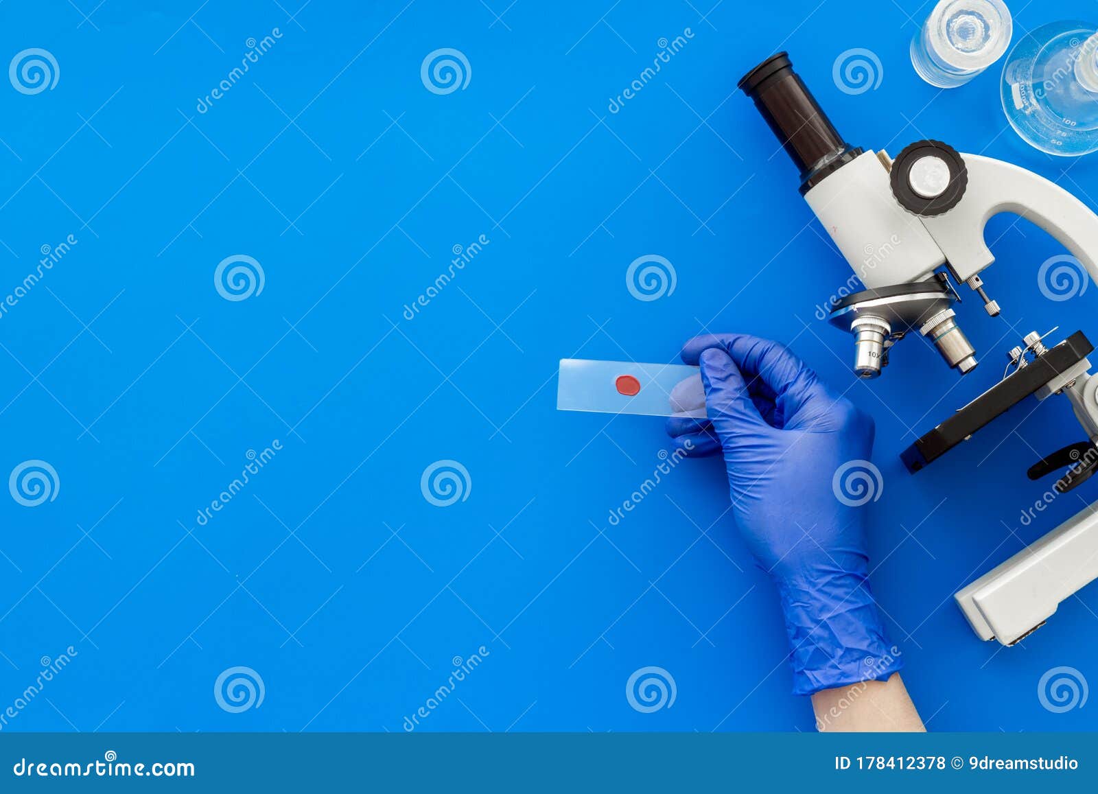 Clinical Science Research with Microscope. Hand Holds Blood Sample on ...