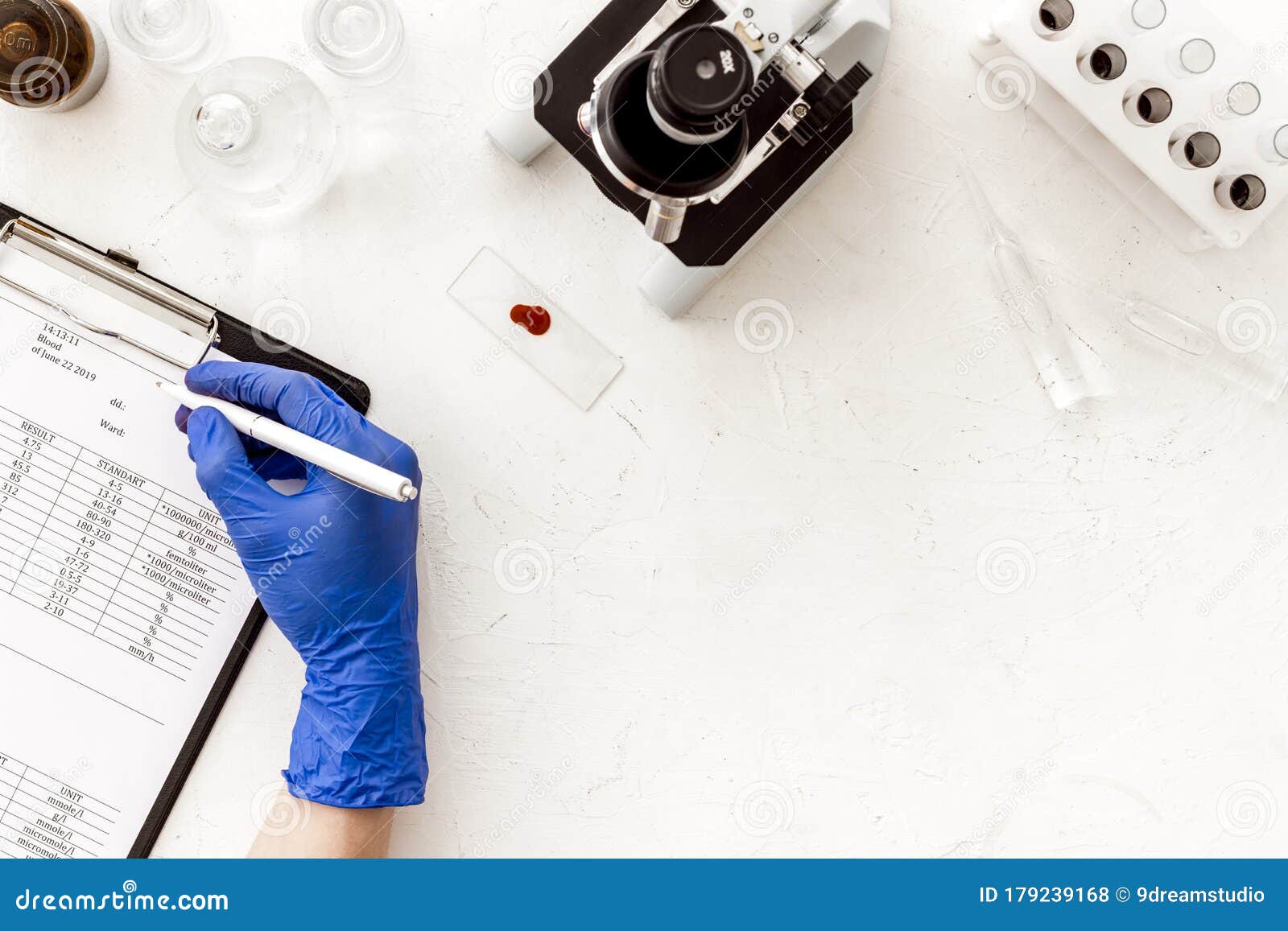Clinical Science Research with Microscope. Hand Writes Test Results on ...