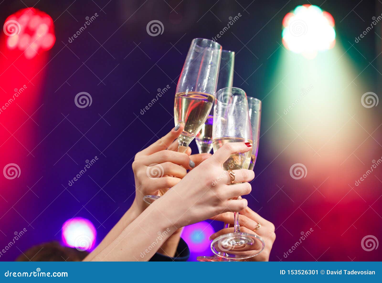 Clinking Glasses of Champagne in Hands on Bright Lights Background ...