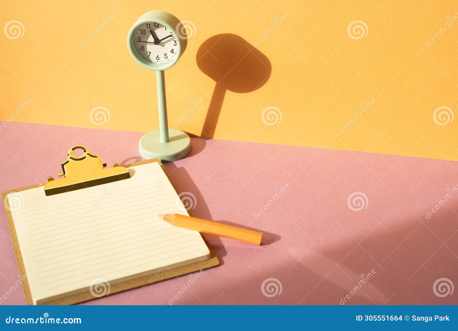 Clipboard and Colored Pencil, Clock on Pink Desk. Orange Wall ...