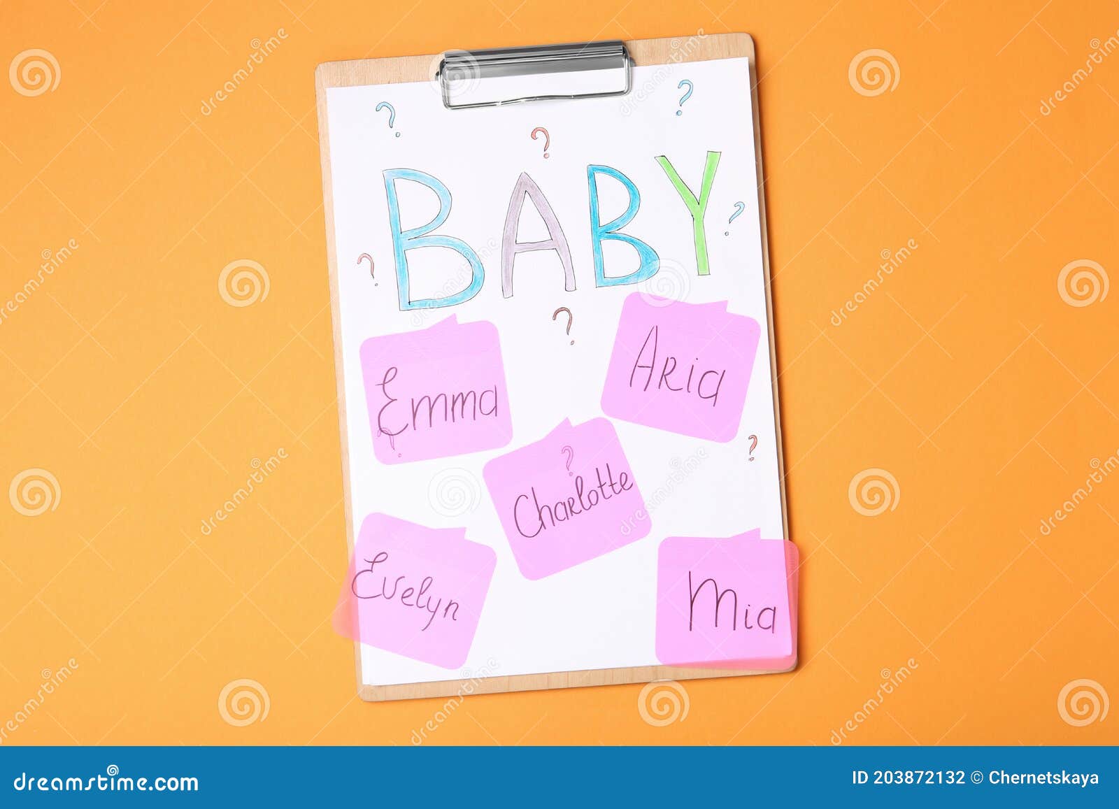 Clipboard with Different Baby Names on Orange Background, Top View ...