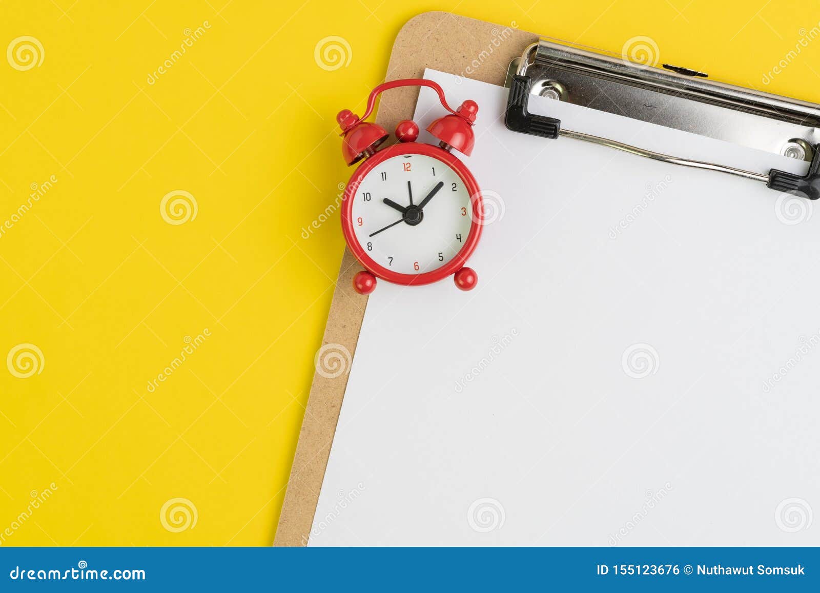 Clipboard with Empty White Paper with Read Alarm Clock on Solid Yellow ...
