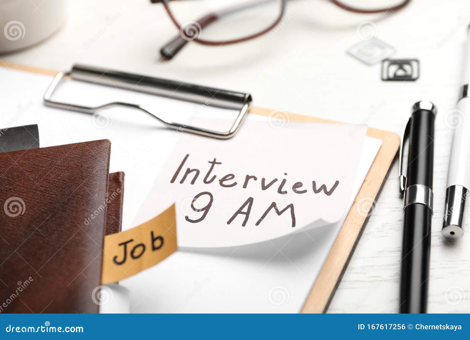 Clipboard with Reminder Note about Job Interview and Stationery on ...