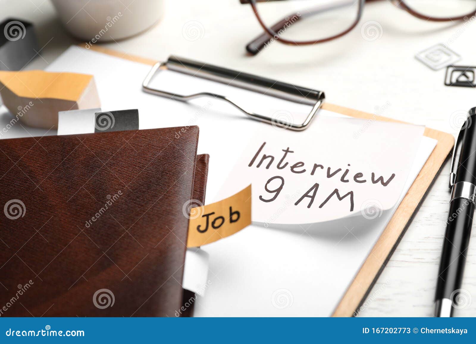 Clipboard with Reminder Note about Job Interview and Stationery on ...