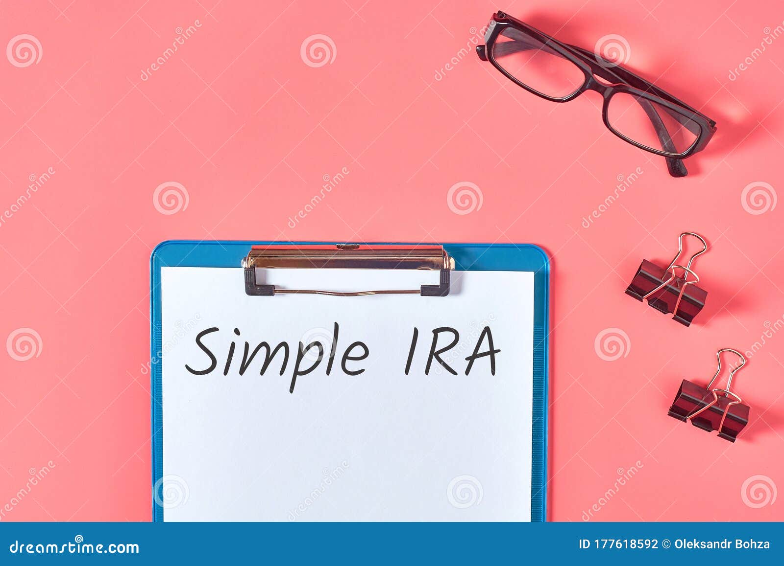 Clipboard with Words Simple Ira Near Stationery Items on Pink Desk ... Clipboard with Words Simple Ira Near Stationery Items on Pink Desk ...