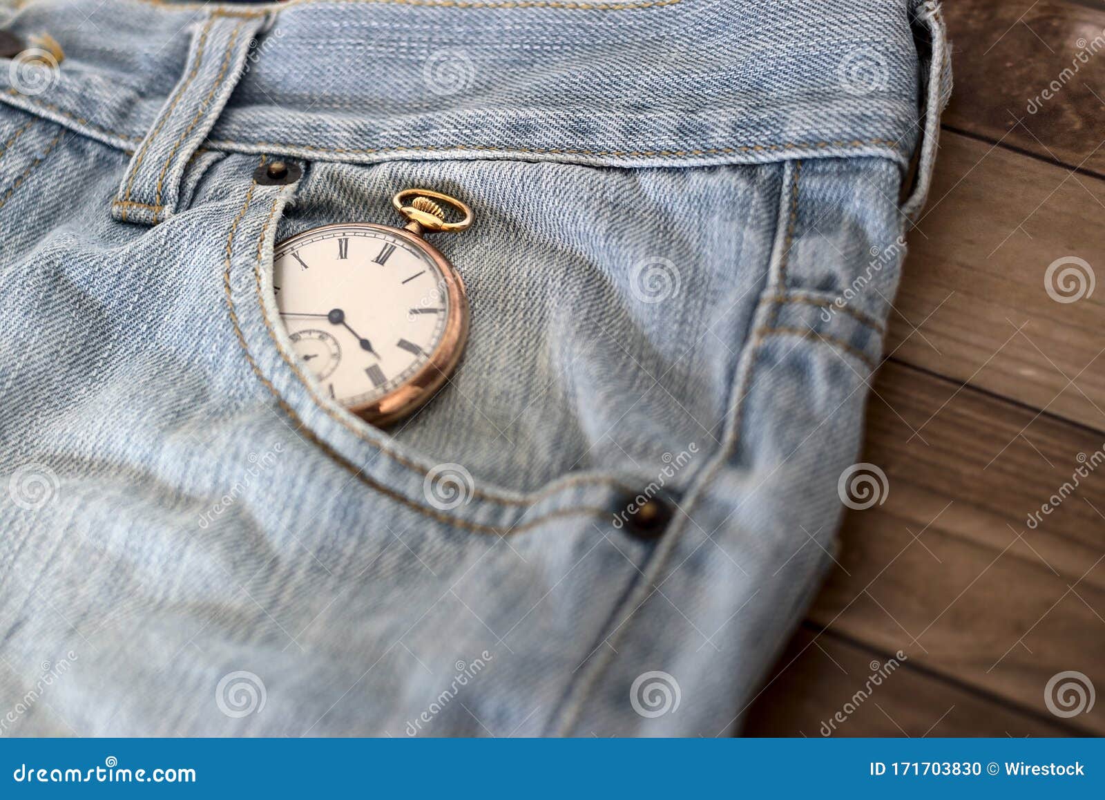 Clock in a Jeans Pocket on a Wooden Surface - Time Management Concept ...