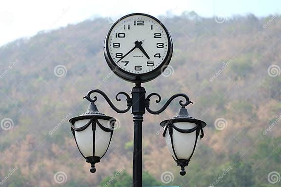 Clock & lamp post stock image. Image of flower, district - 49195419