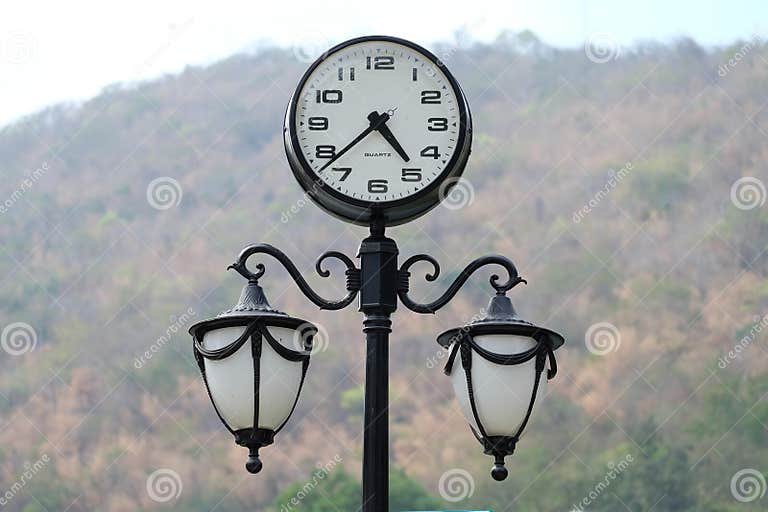 Clock & lamp post stock image. Image of flower, district - 49195419