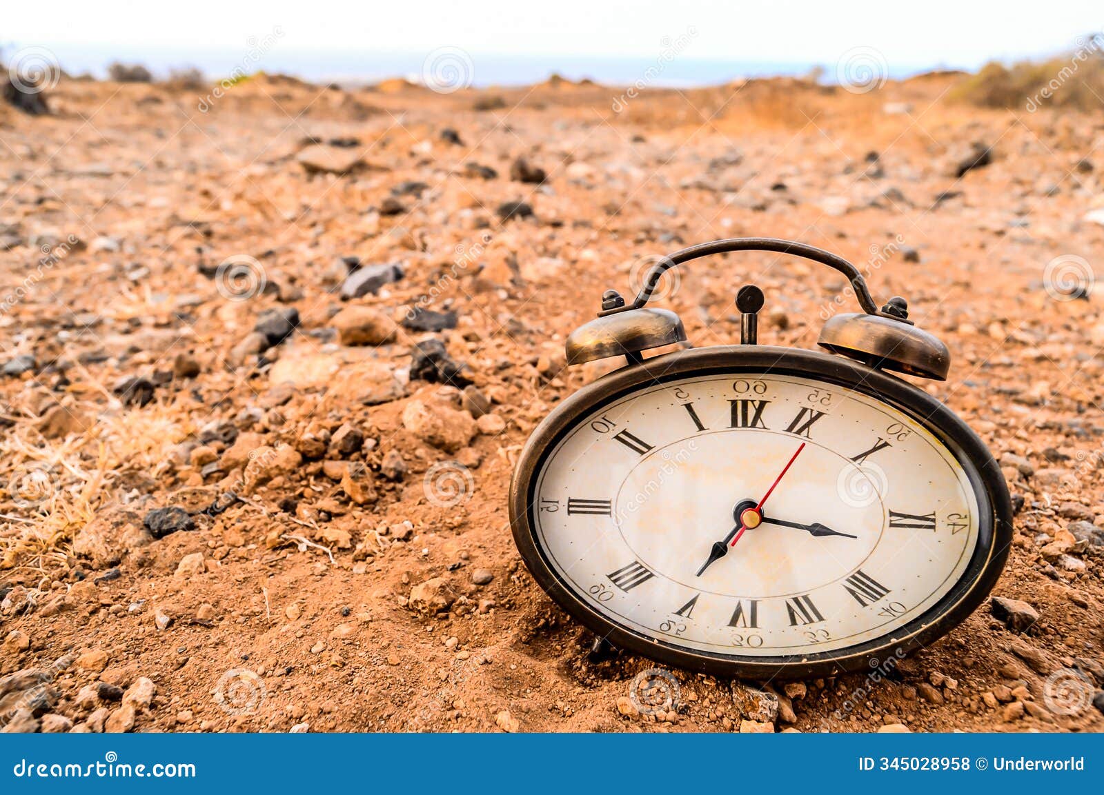 A Clock is Laying on the Ground in a Desert Stock Photo - Image of ...