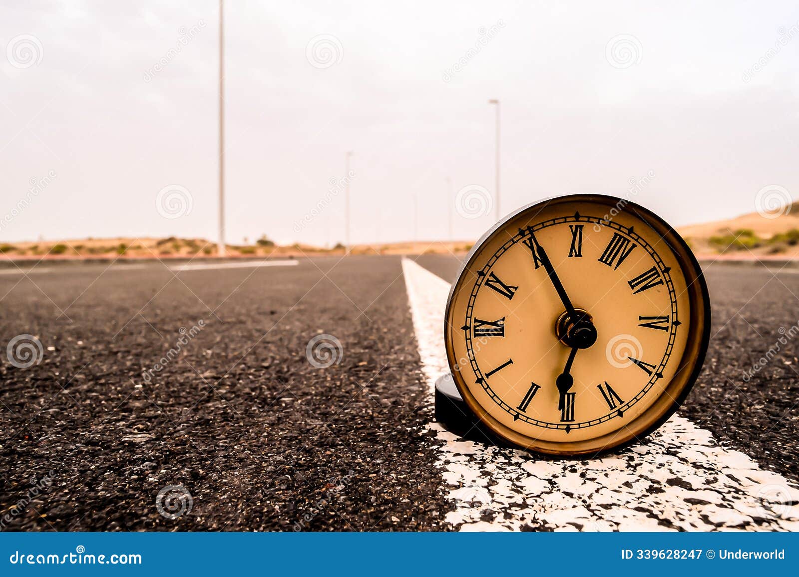 A Clock is Laying on the Road, with the Hands Pointing To the Numbers 1 ...