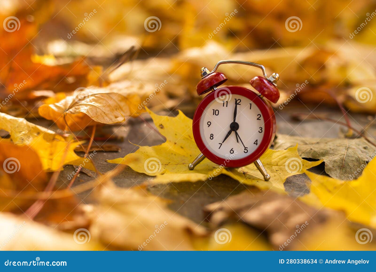 Clock and Leaves on Yellow Background with Bokeh Stock Photo - Image of ...