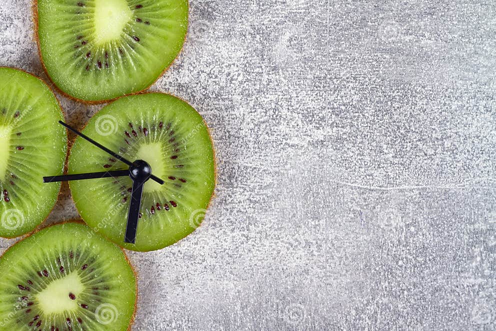 A Clock Made of Green Kiwi Fruit Shows the Time Stock Image - Image of ...