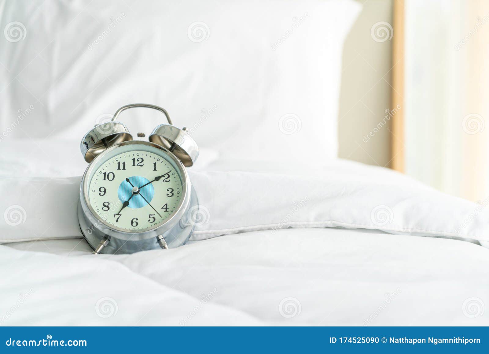 Clock on white bed stock photo. Image of napping, alert - 174525090